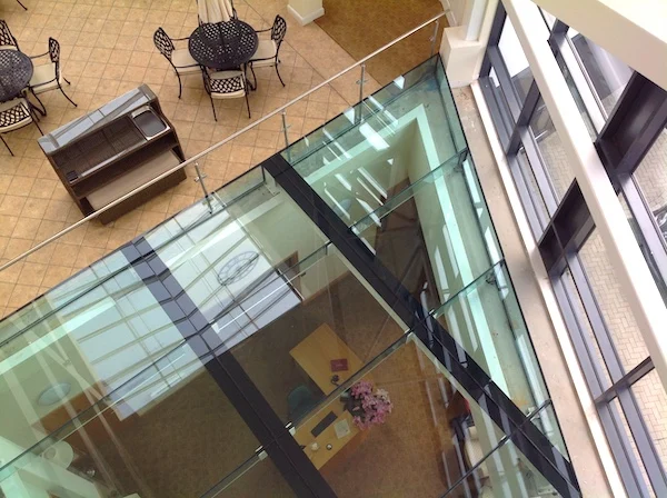 reception hall large structural glass floor multiple panels joined ...